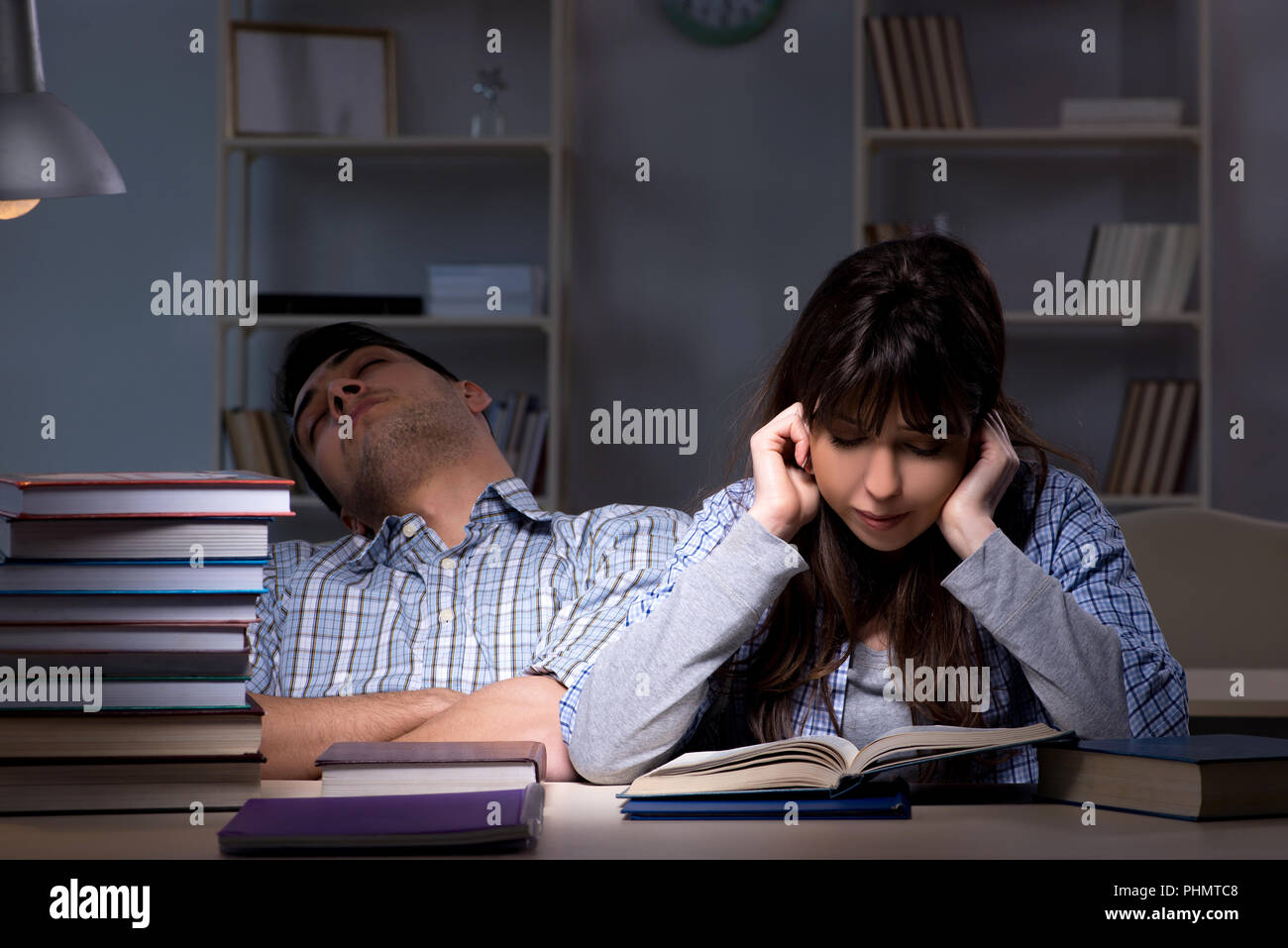 Two students studying late at night Stock Photo - Alamy