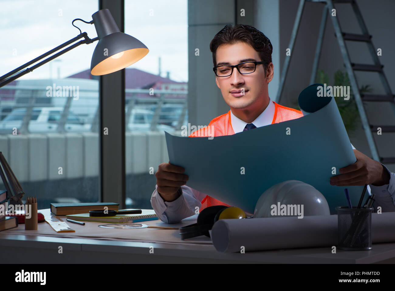 Construction architect working on drawings late at night Stock Photo ...