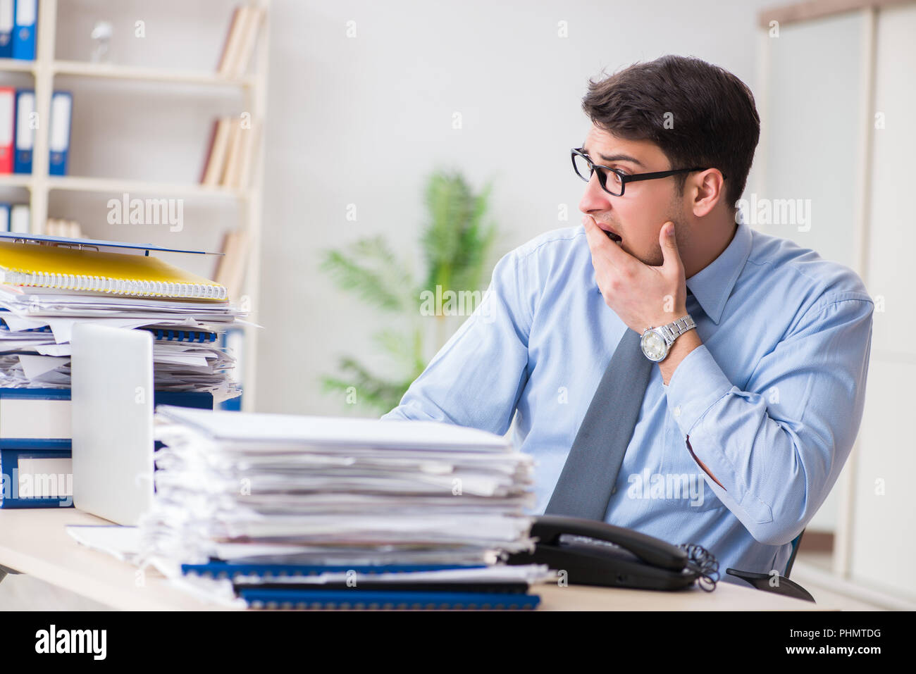 Extremely busy businessman working in office Stock Photo - Alamy