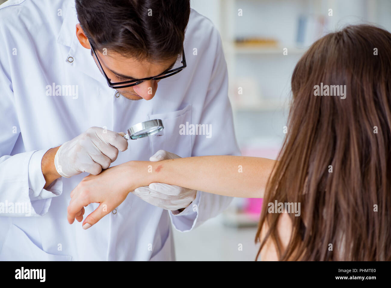 Doctor examining patient skin in hospital Stock Photo - Alamy