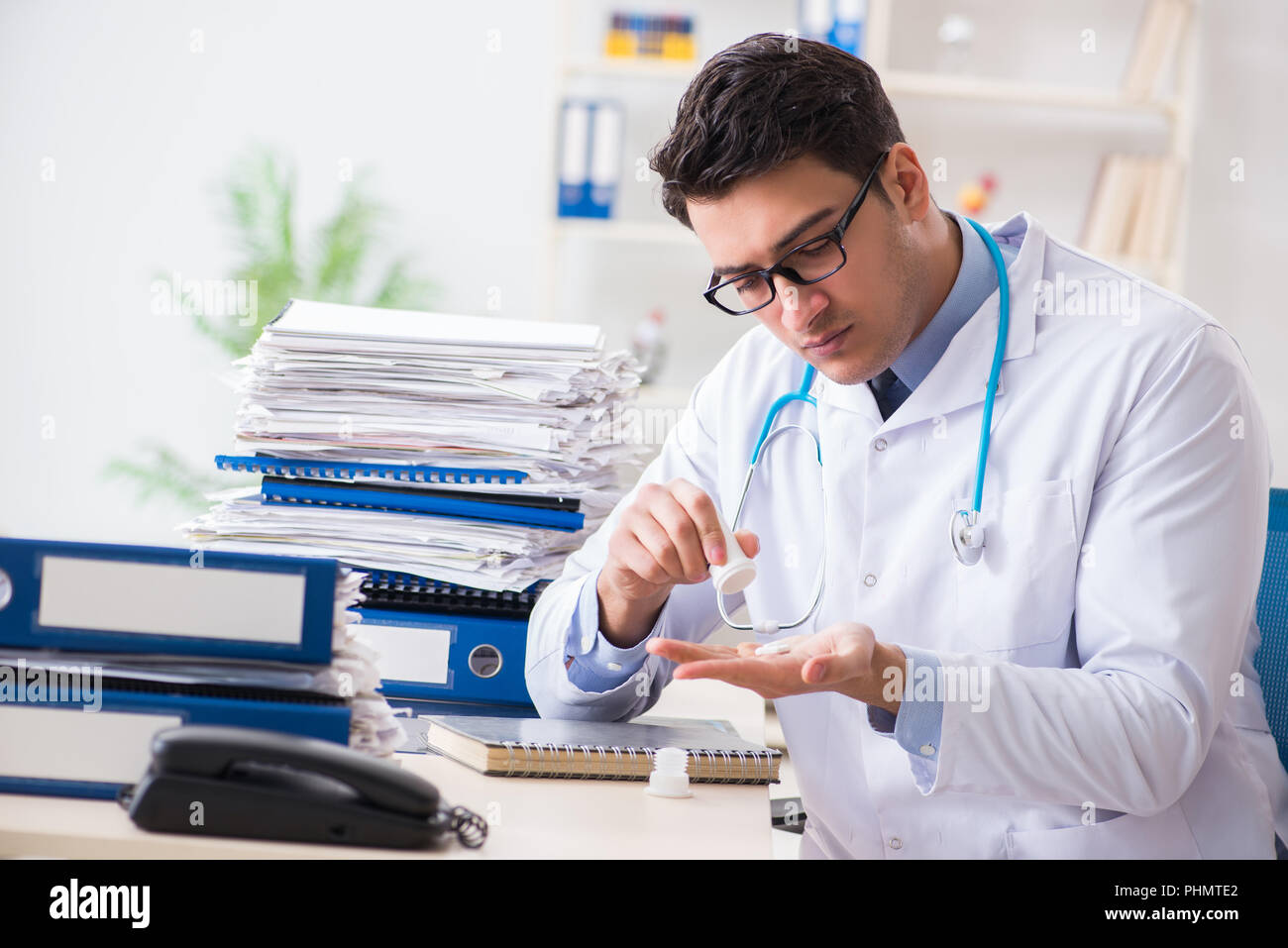 Busy doctor with too much work in hospital Stock Photo - Alamy