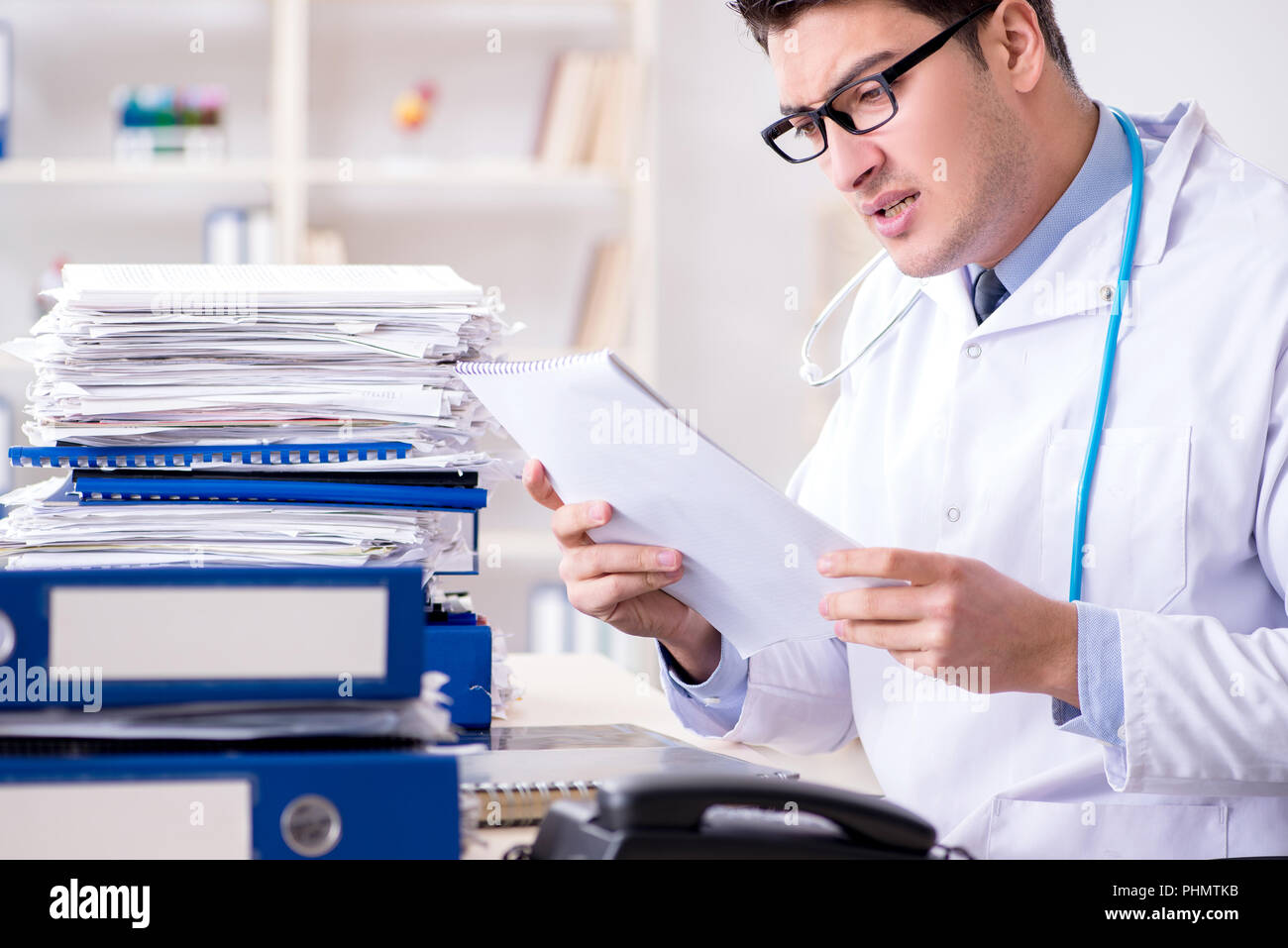 Busy doctor with too much work in hospital Stock Photo - Alamy