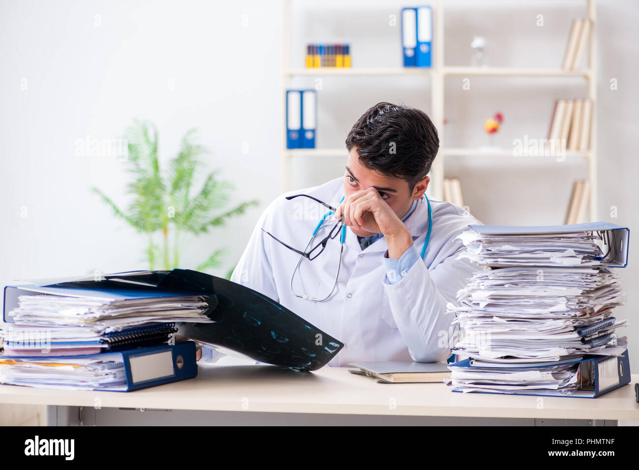 Tired radiologist with x-ray image in hospital Stock Photo - Alamy