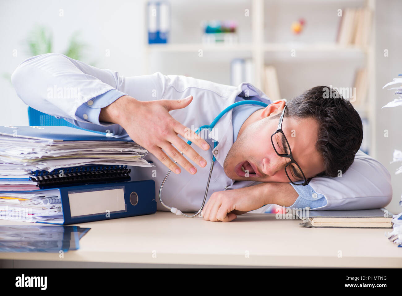 Busy doctor with too much work in hospital Stock Photo - Alamy