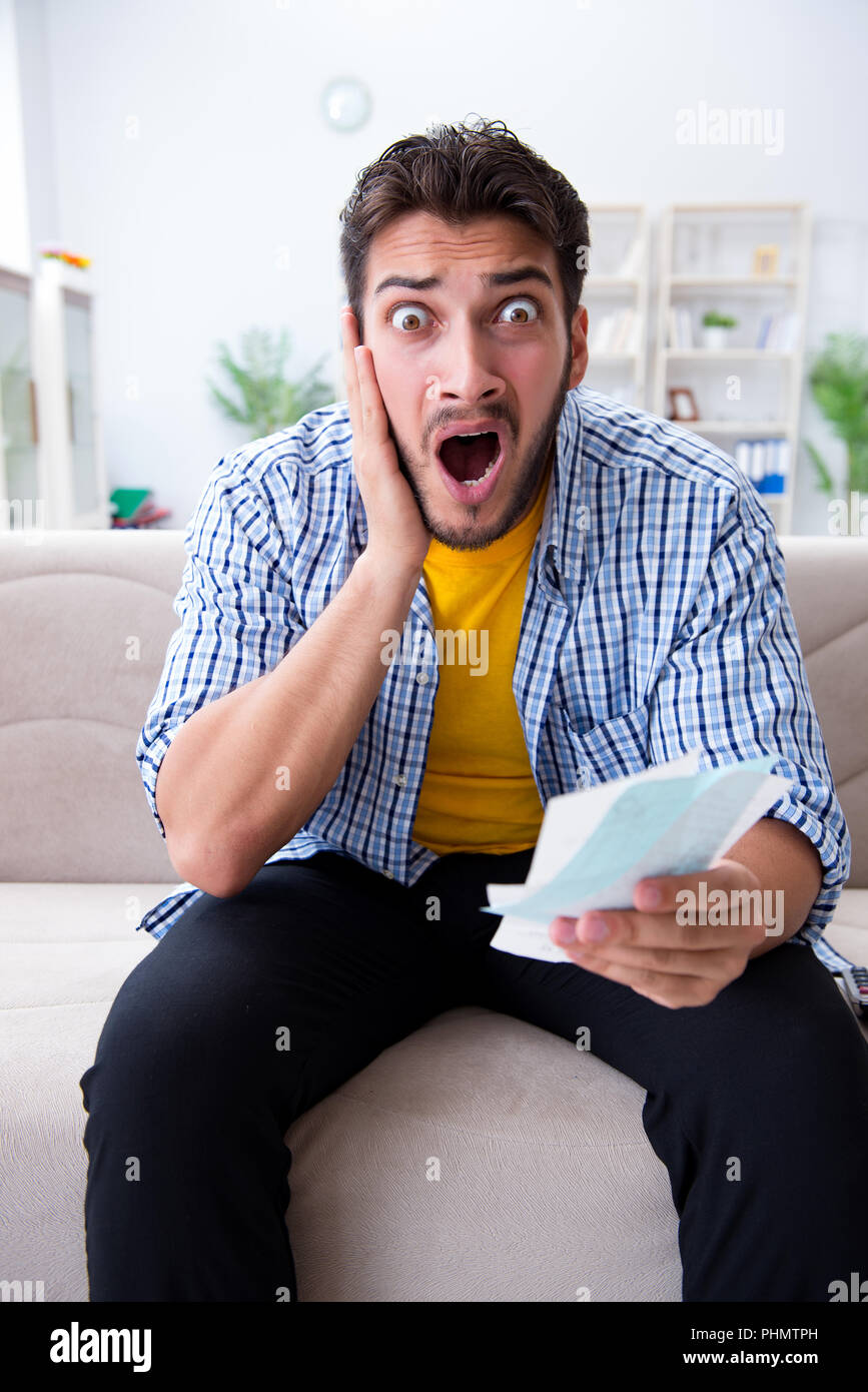 Angry looking at bills hi-res stock photography and images - Alamy