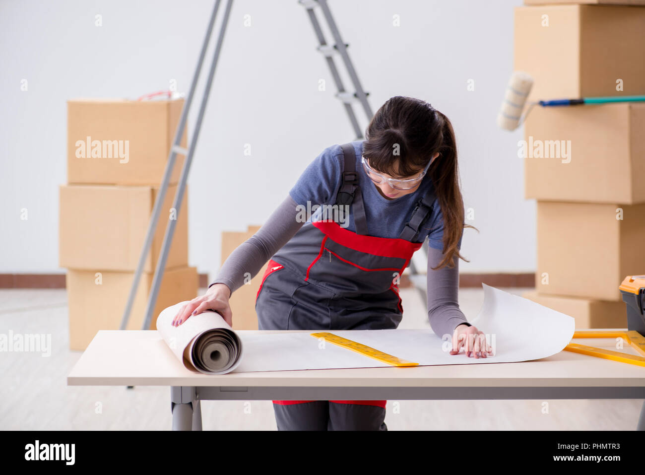 Woman preparing for wallpaper work Stock Photo - Alamy