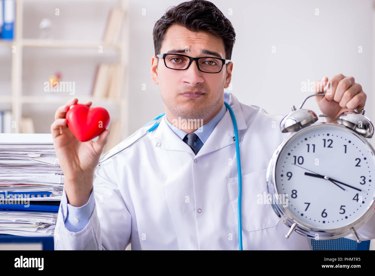 Doctor with alarm clock in urgent check-up concept Stock Photo - Alamy