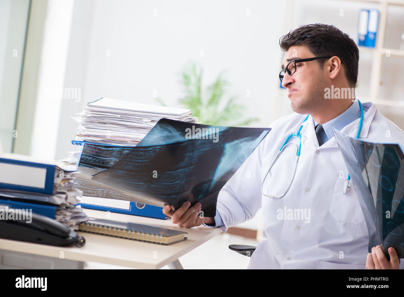 Tired radiologist with x-ray image in hospital Stock Photo - Alamy