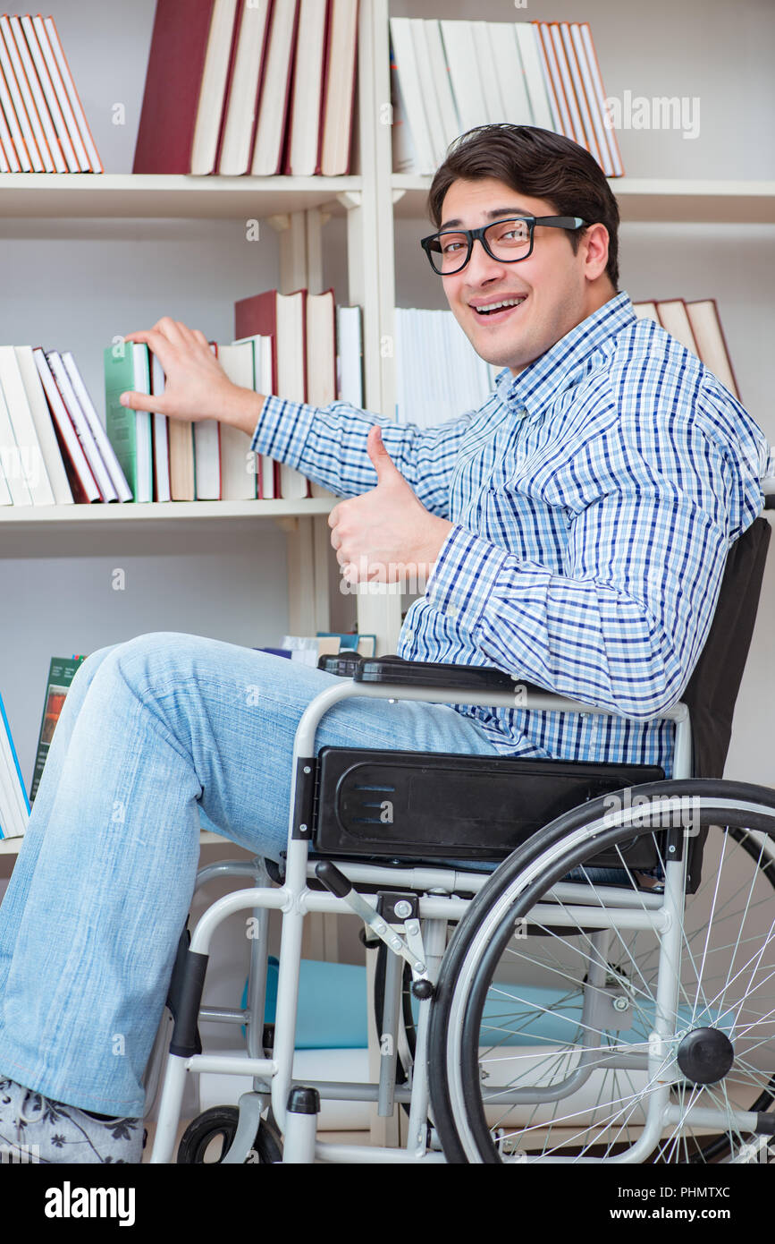 Disabled student studying in the library Stock Photo - Alamy