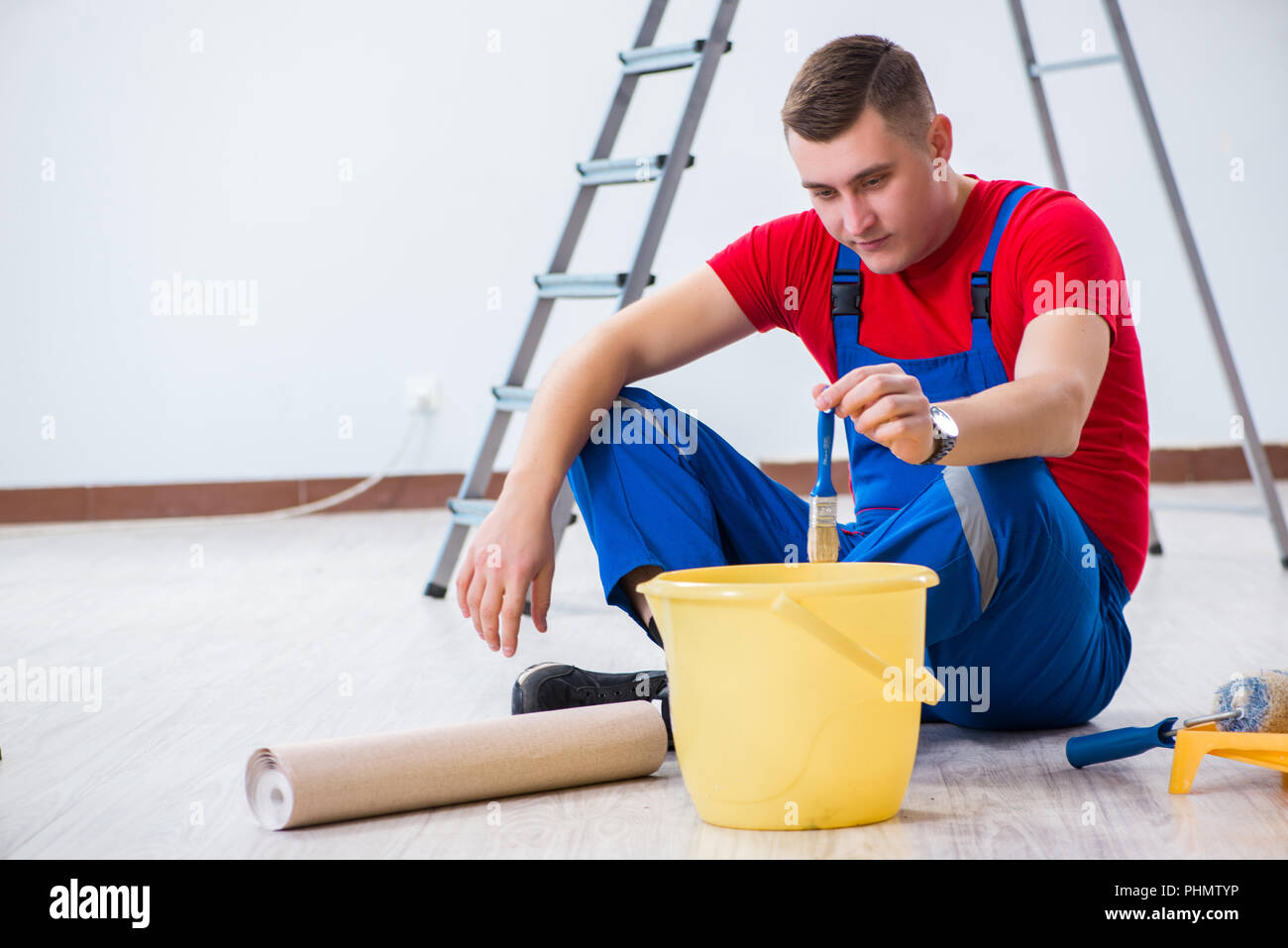 Male painter preparing for painting job at construction site Stock ...