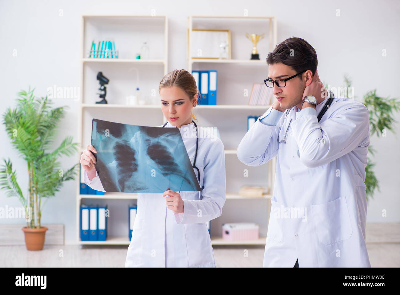 Two doctors examining x-ray images of patient for diagnosis Stock Photo ...