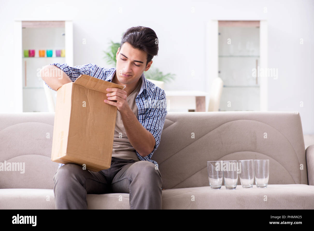 Man receiving wrong parcel with glasses Stock Photo - Alamy