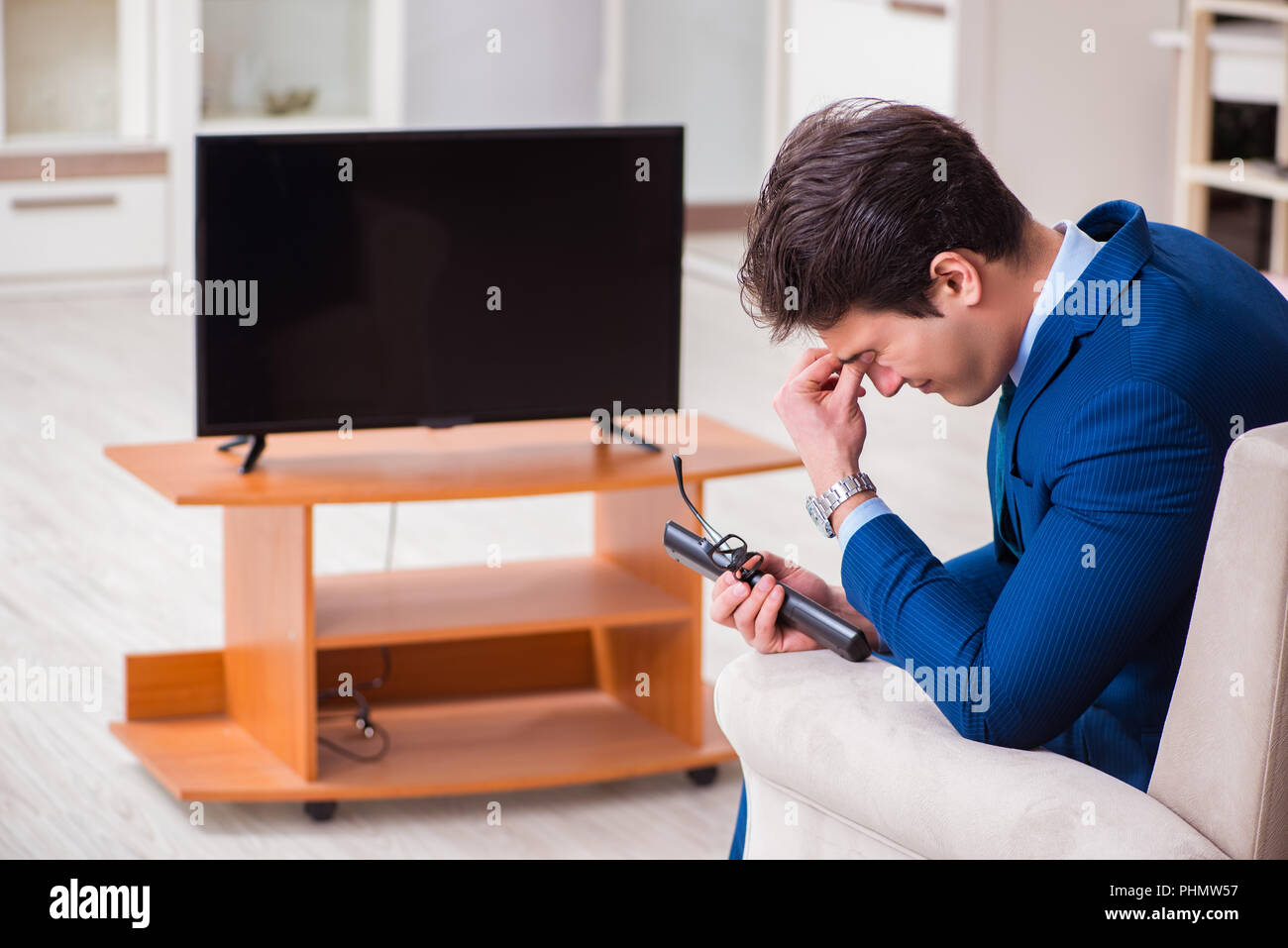 Businesman watching tv in office Stock Photo - Alamy