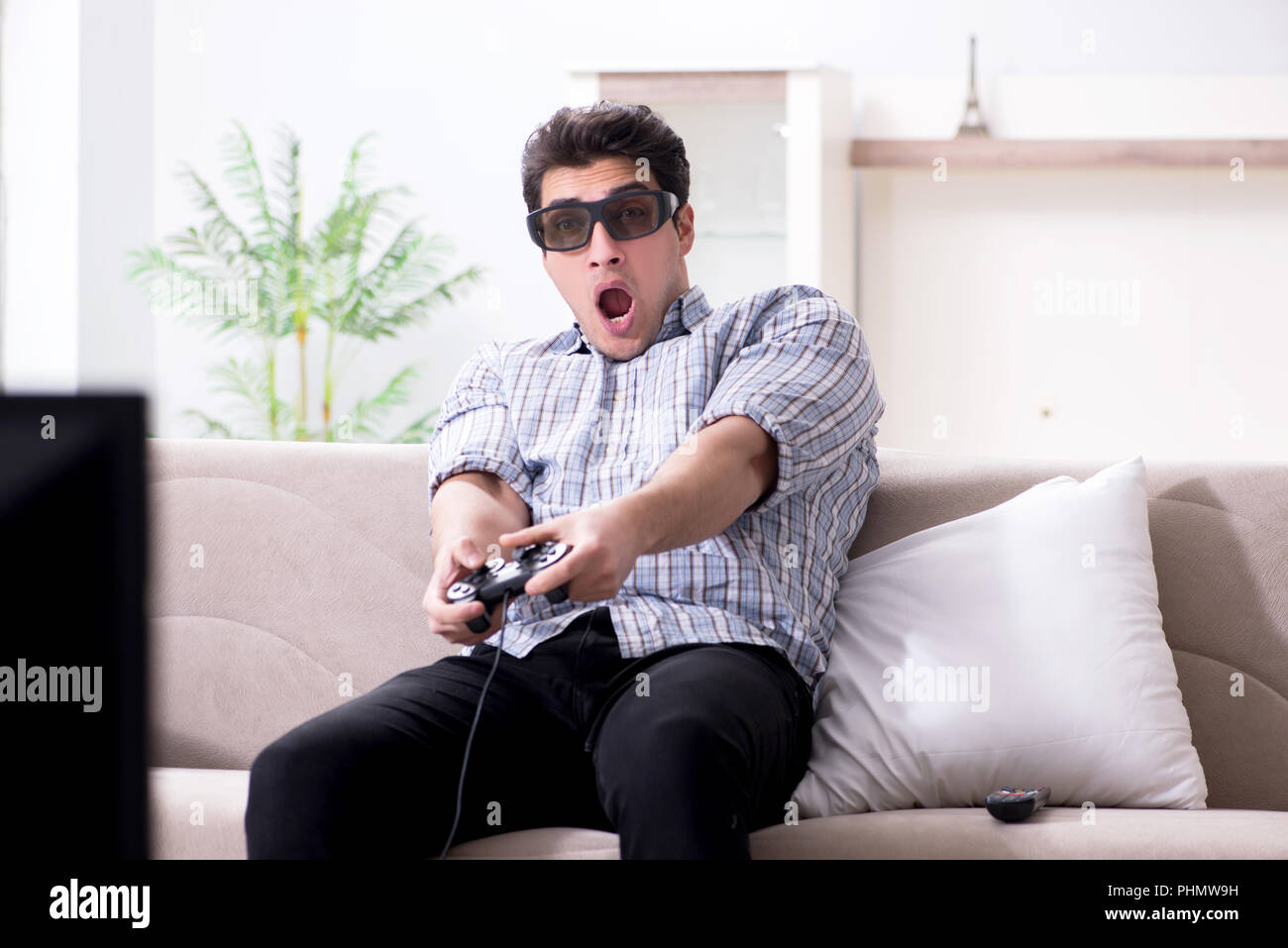 Man playing 3d games at home Stock Photo - Alamy