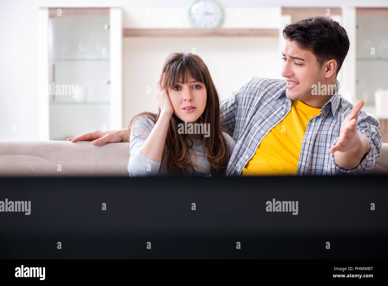 Pair watching tv at home Stock Photo - Alamy
