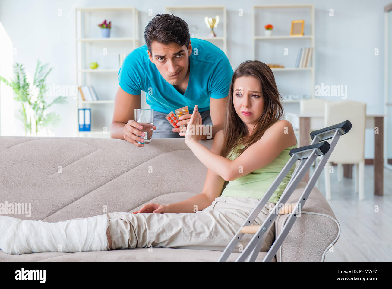 Husband man supporting injured wife Stock Photo - Alamy