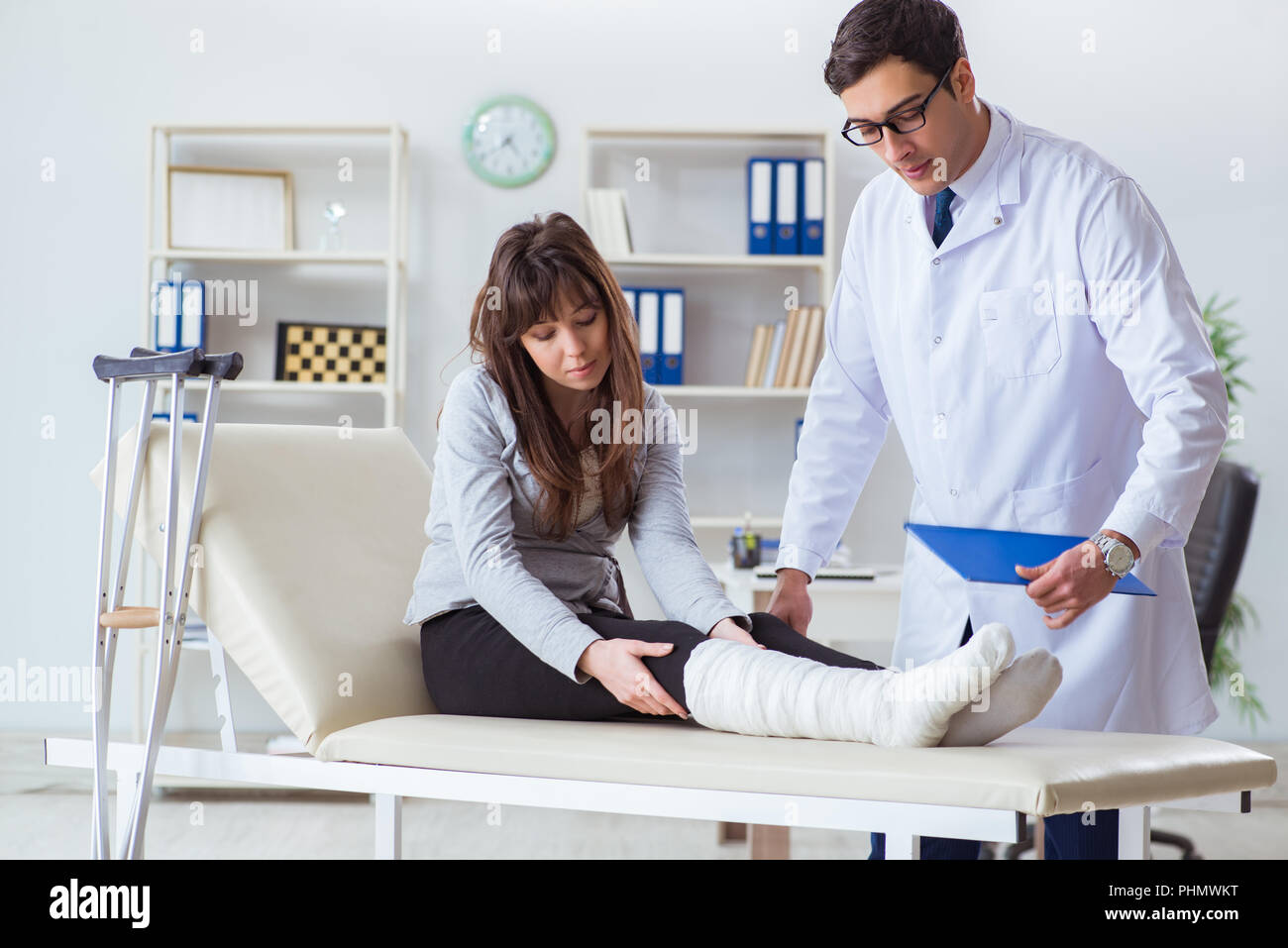 Doctor examining patient with broken leg Stock Photo - Alamy