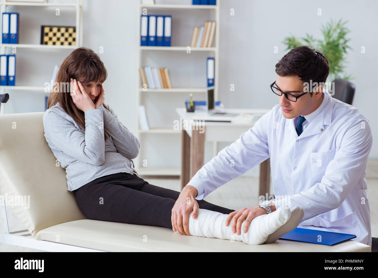 Doctor examining patient with broken leg Stock Photo - Alamy