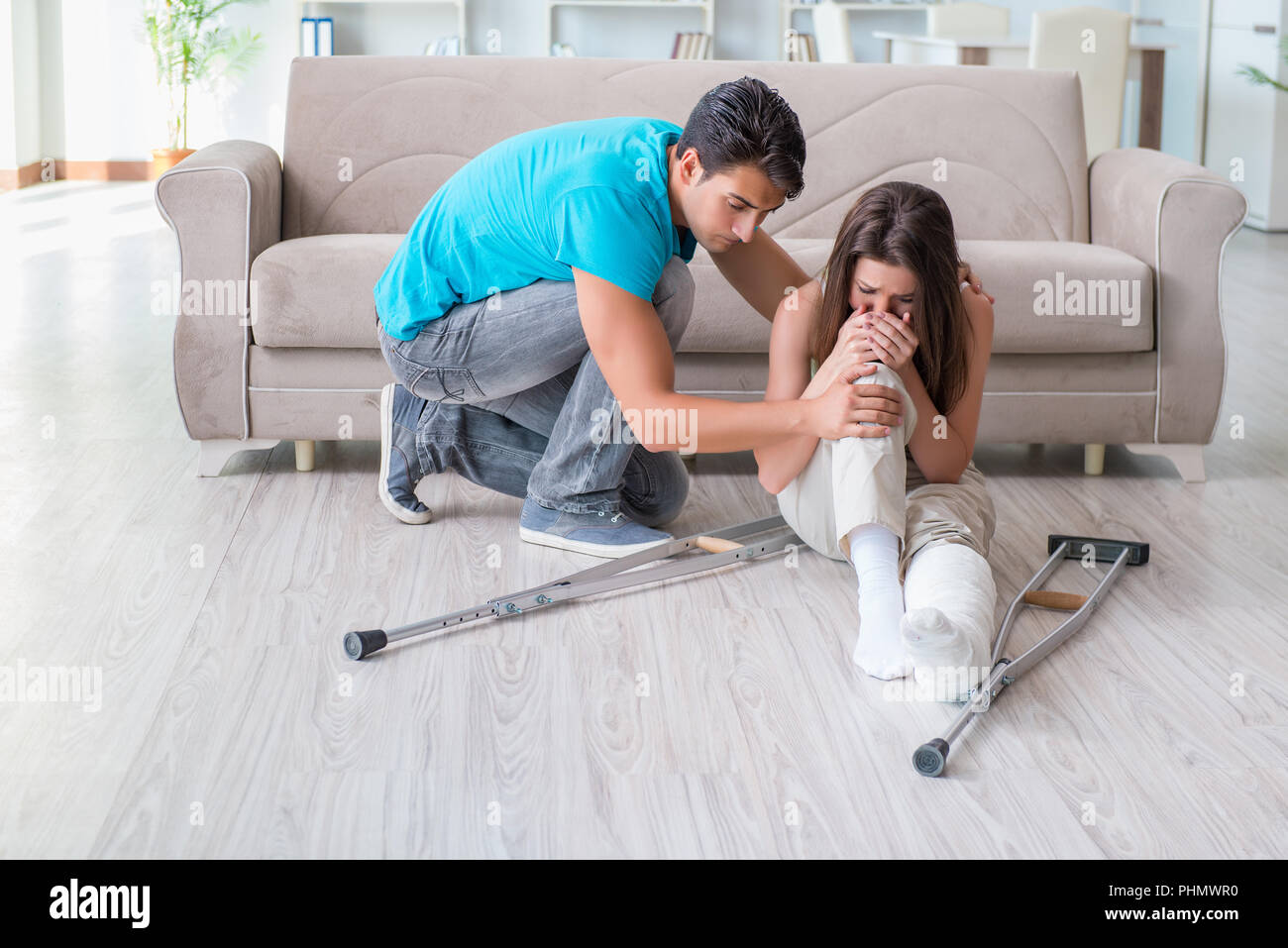 Husband man supporting injured wife Stock Photo - Alamy