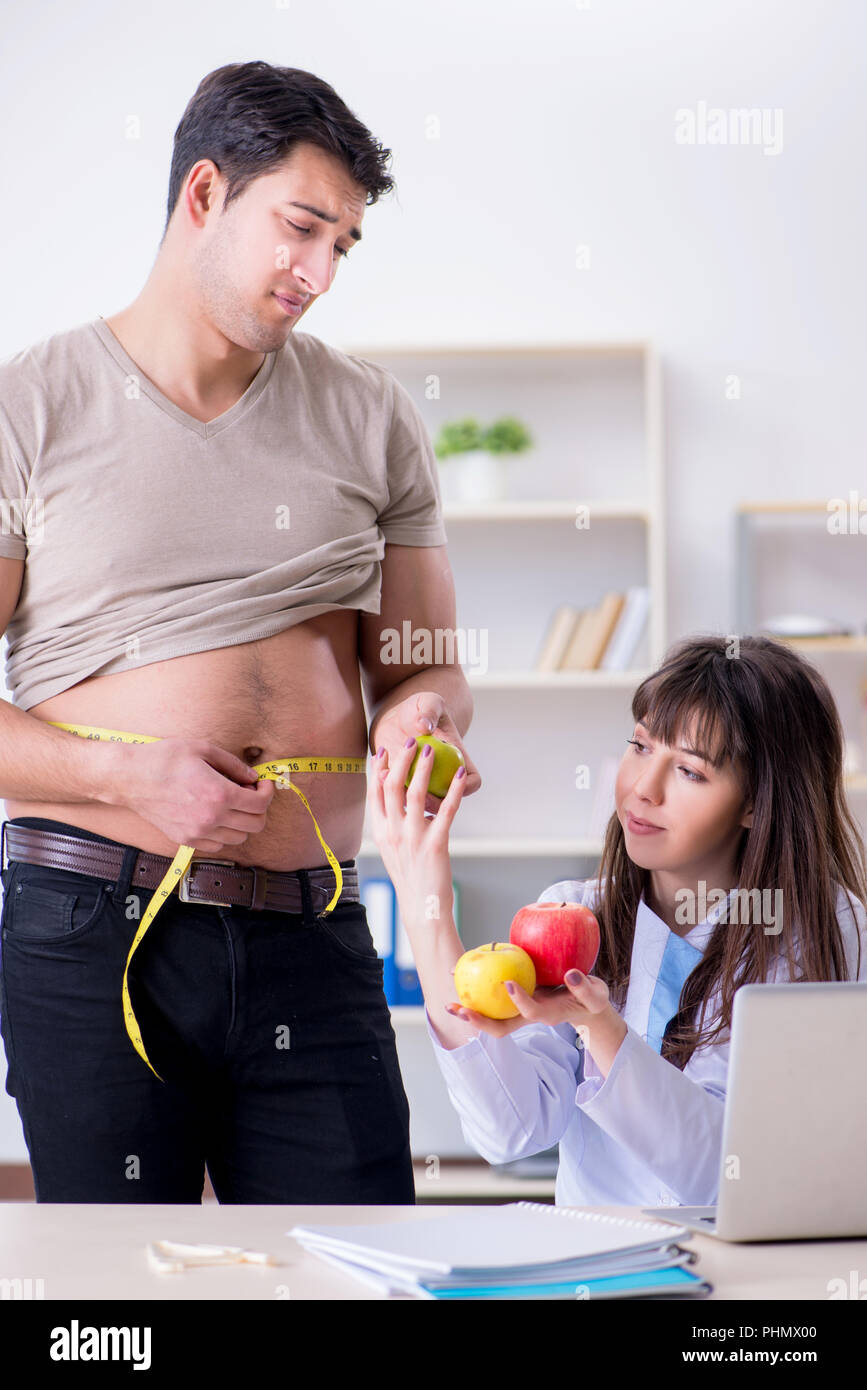 Doctor dietician giving advices to fat overweight patient Stock Photo ...