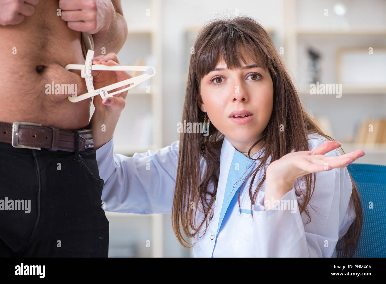 Doctor dietician giving advices to fat overweight patient Stock Photo ...