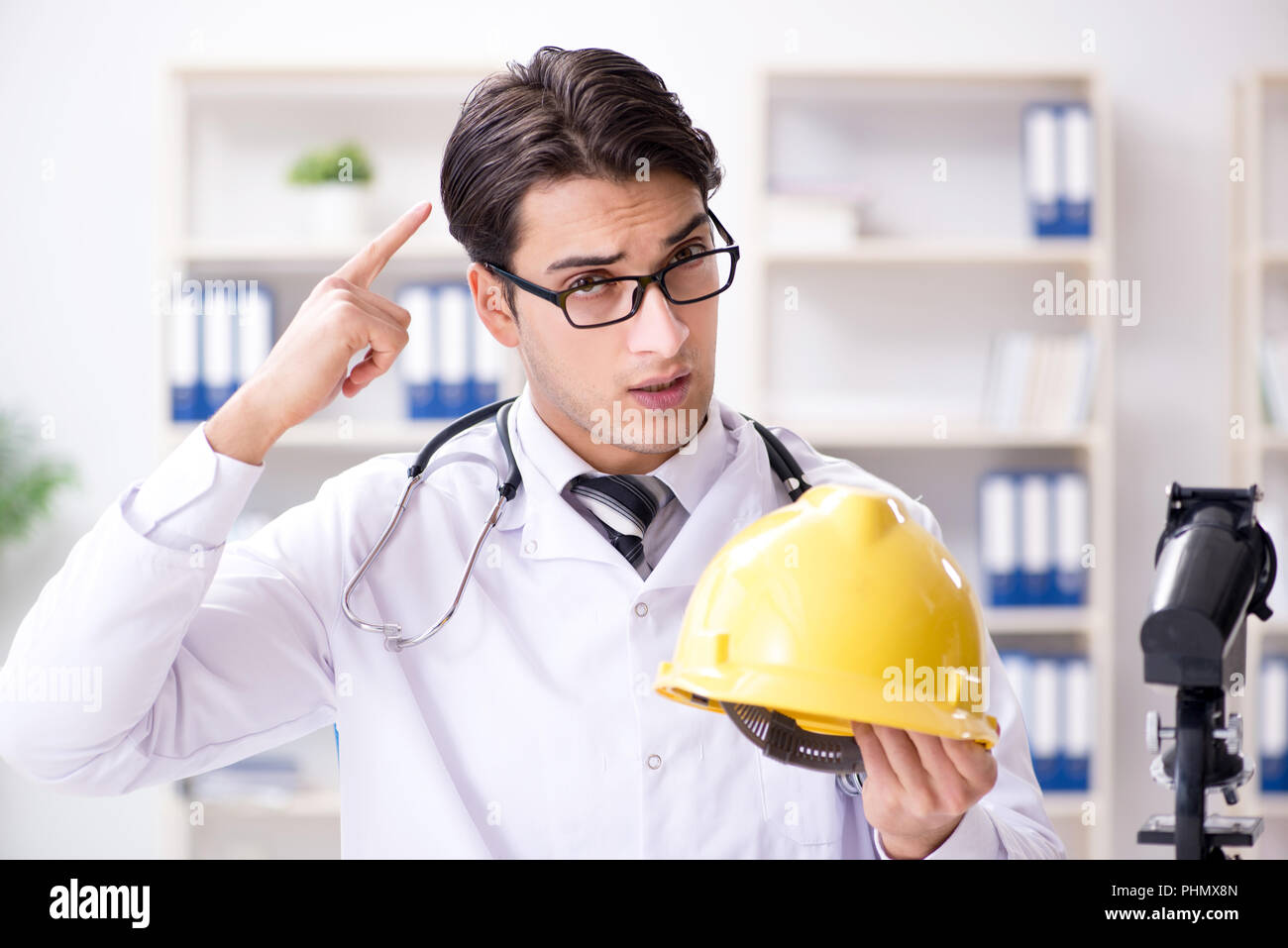 Safety doctor advising about wearing hard hat Stock Photo - Alamy