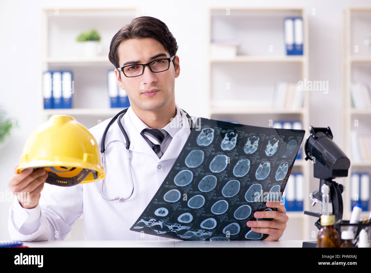 Safety doctor advising about wearing hard hat Stock Photo - Alamy