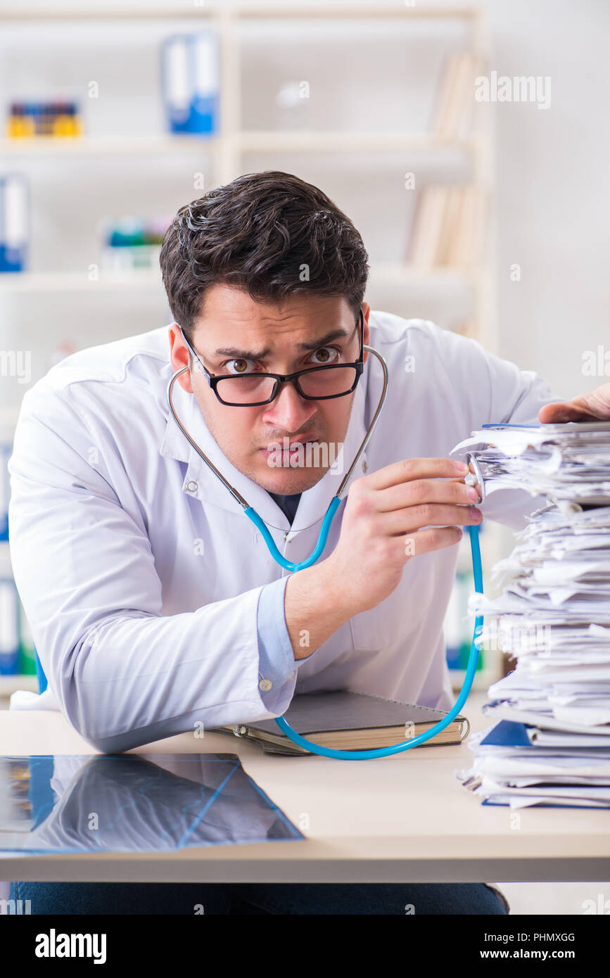 Busy doctor with too much work in hospital Stock Photo - Alamy