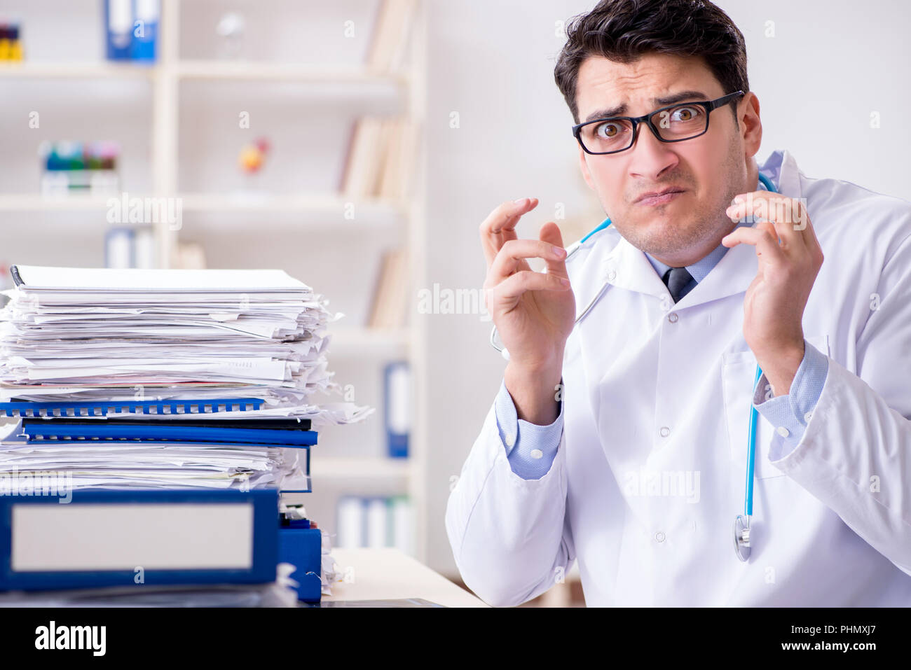 Busy doctor with too much work in hospital Stock Photo - Alamy