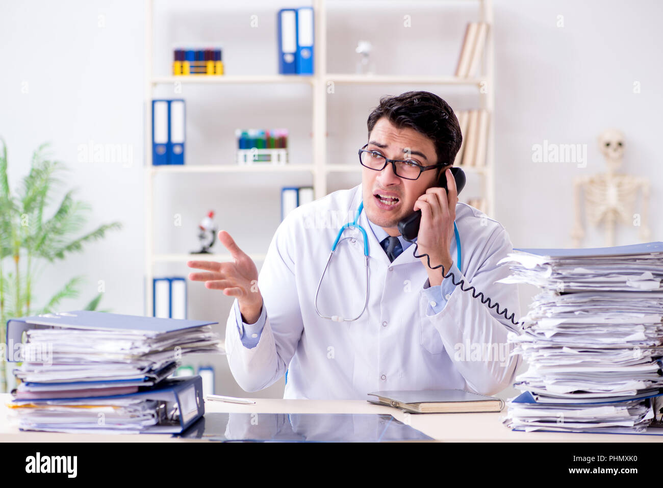 Busy doctor with too much work in hospital Stock Photo - Alamy