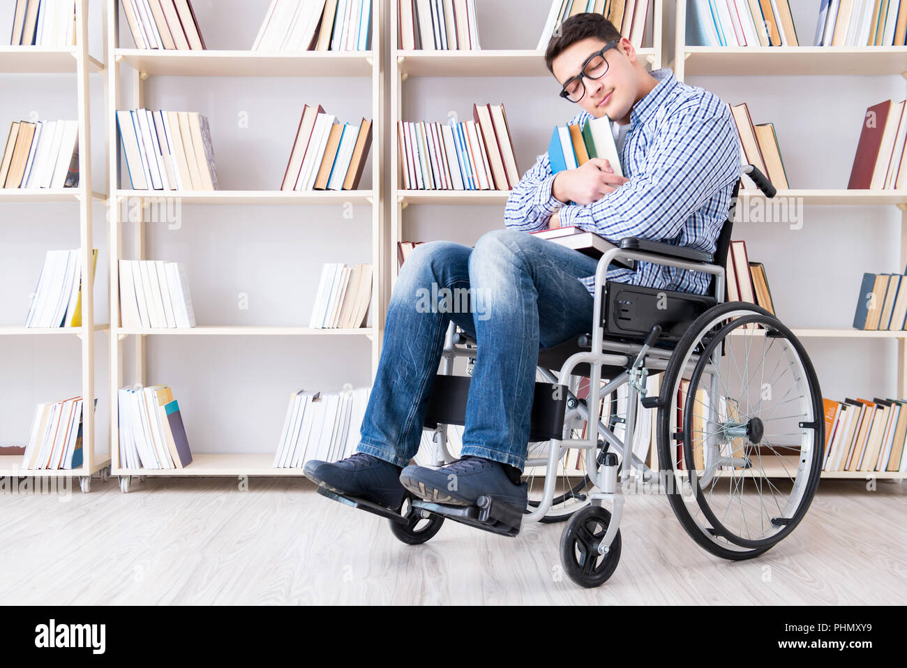 Disabled student studying in the library Stock Photo - Alamy