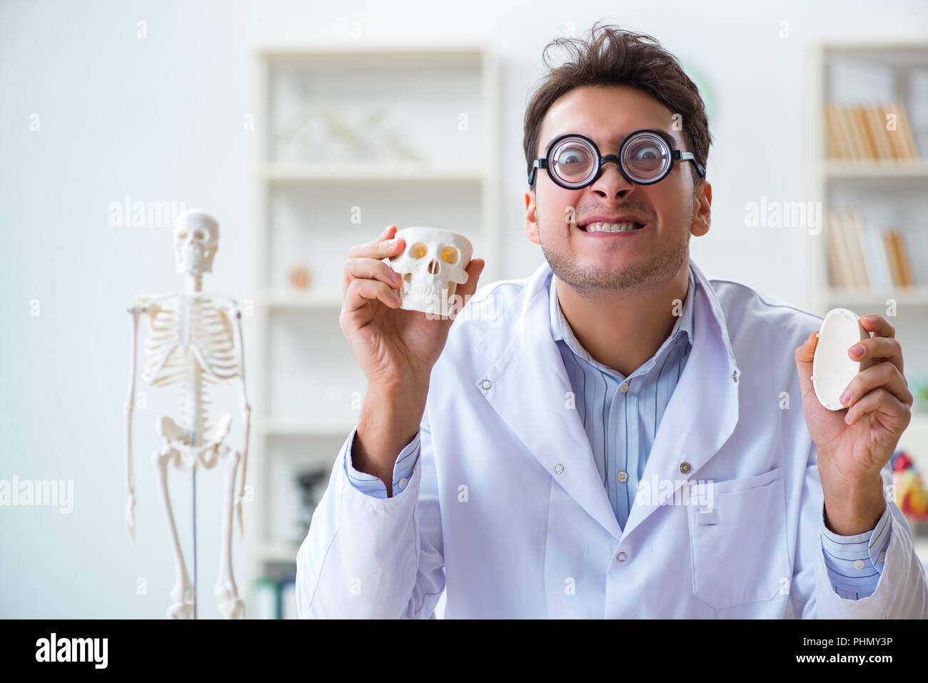 Crazy doctor studying human skeleton Stock Photo - Alamy