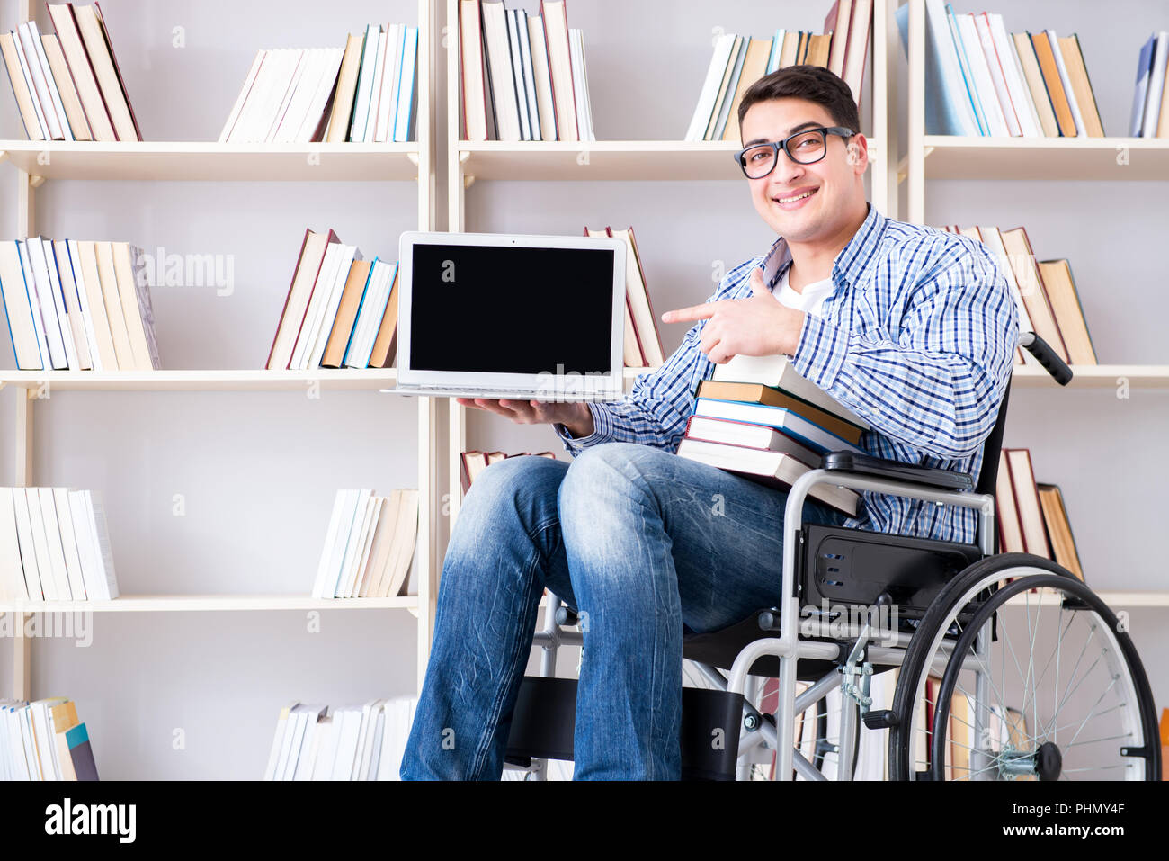 Disabled student studying in the library Stock Photo - Alamy