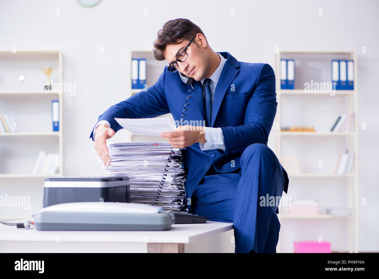 Businessman making copies in copying machine Stock Photo - Alamy