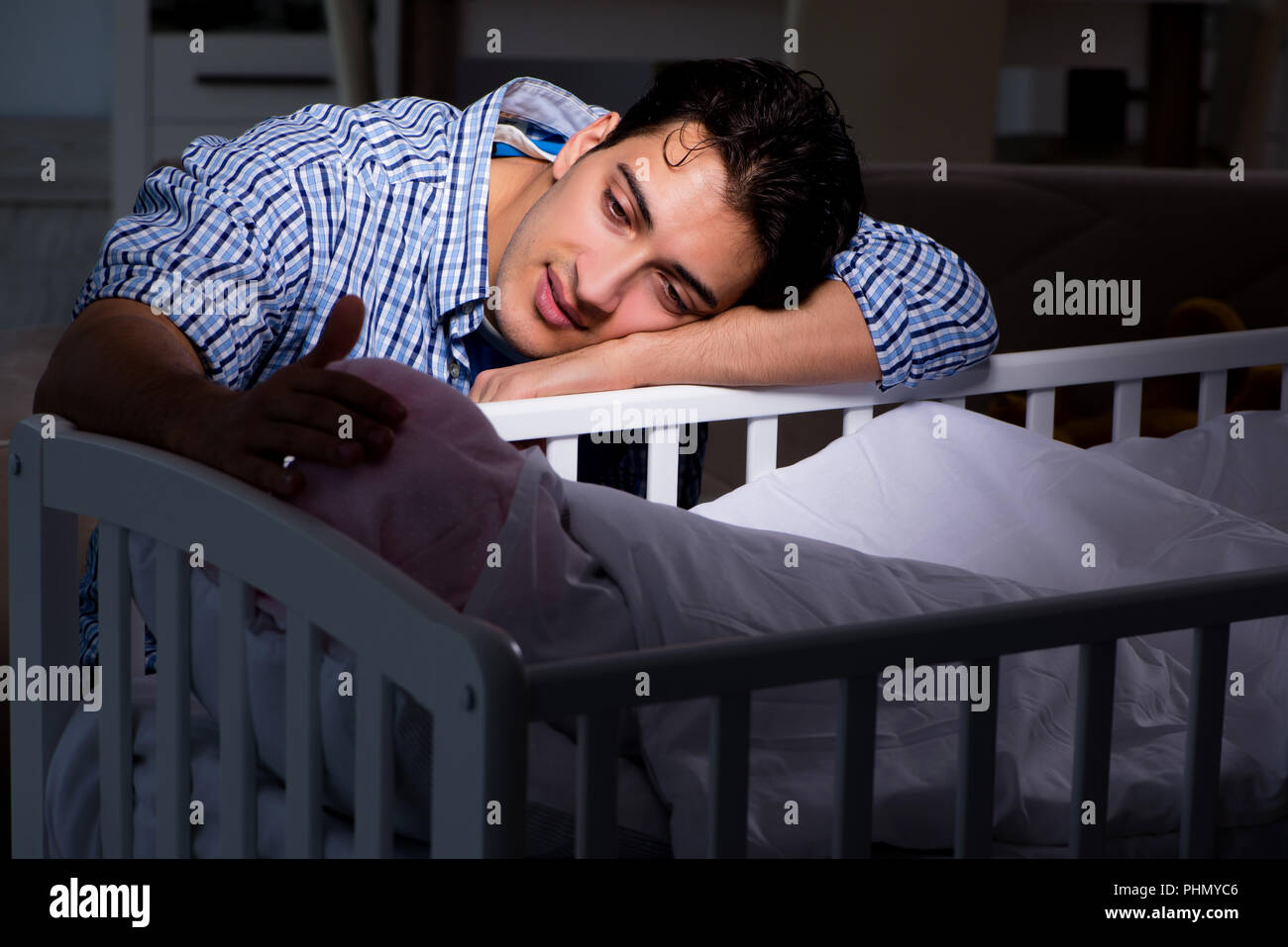 Young father dad sleeping while looking after newborn baby Stock Photo ...