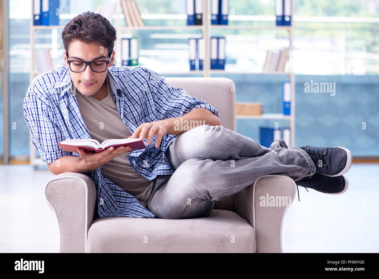 Student reading books and preparing for exams in library Stock Photo ...