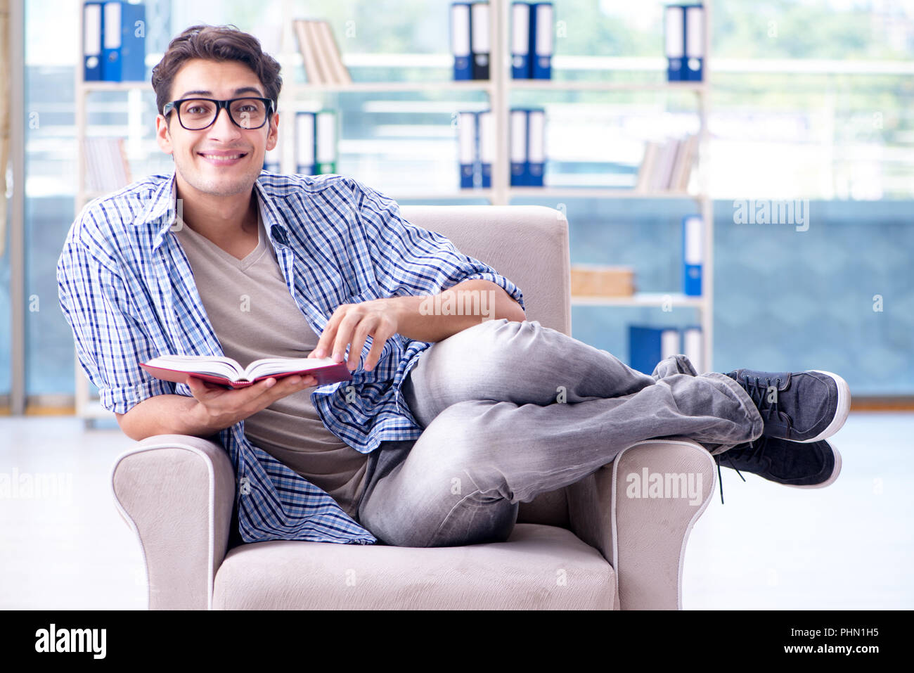 Student reading books and preparing for exams in library Stock Photo ...
