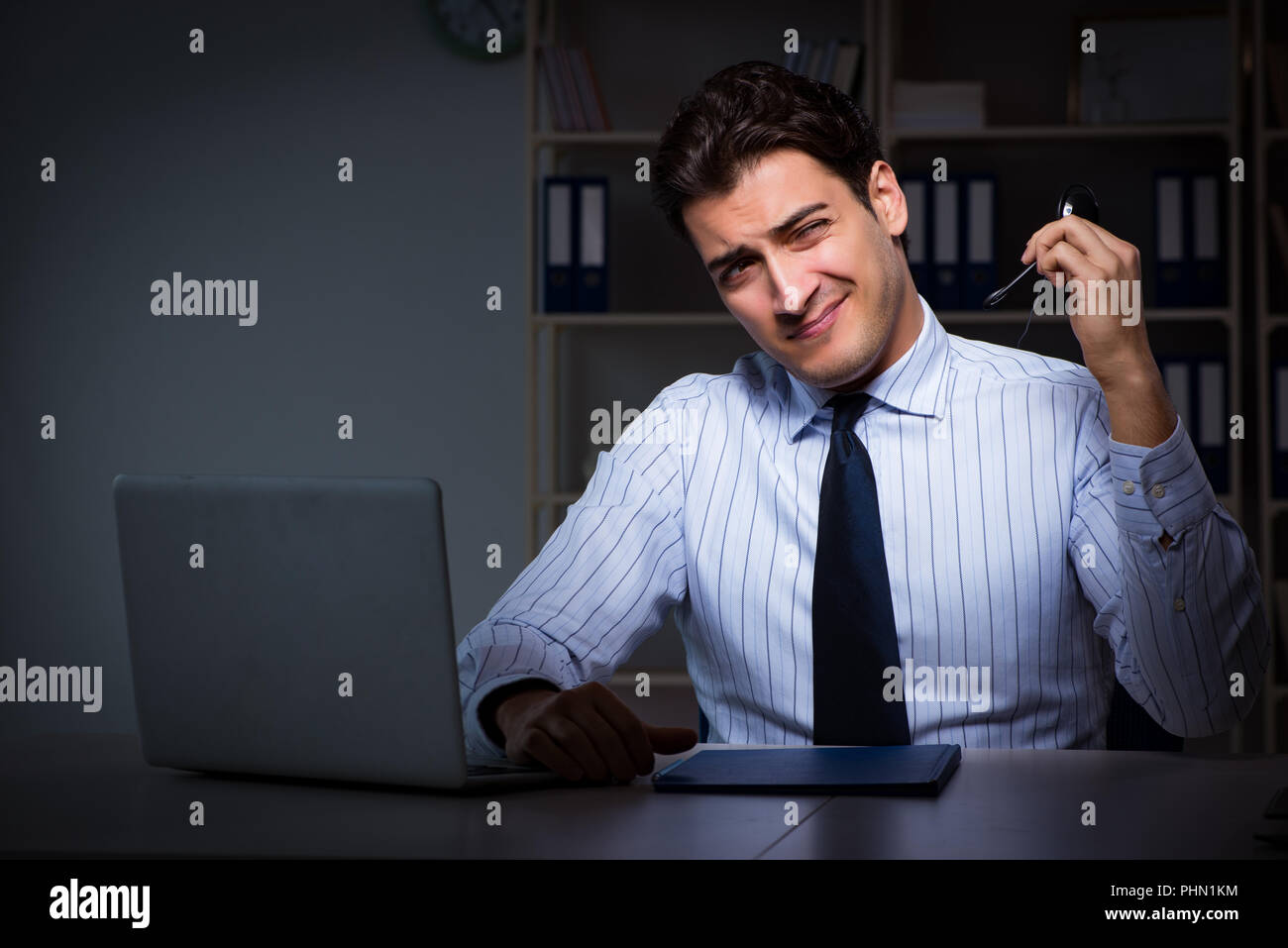 Tired and exhausted helpdesk operator during night shift Stock Photo ...