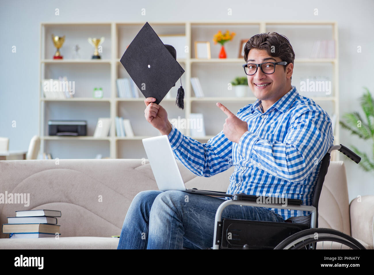 Young student on wheelchair in disability concept Stock Photo - Alamy