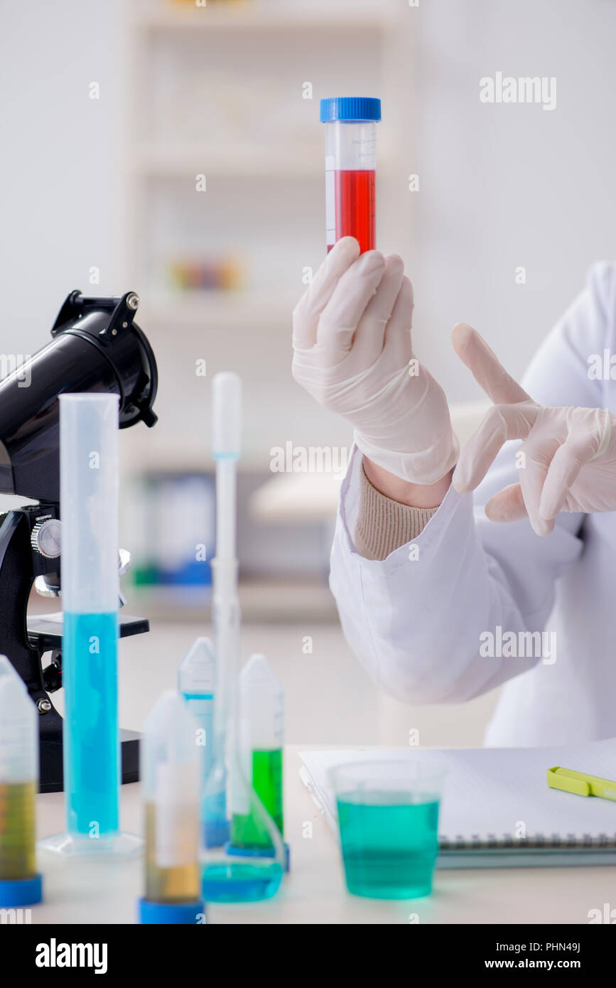 Woman doctor checking blood samples in lab Stock Photo - Alamy