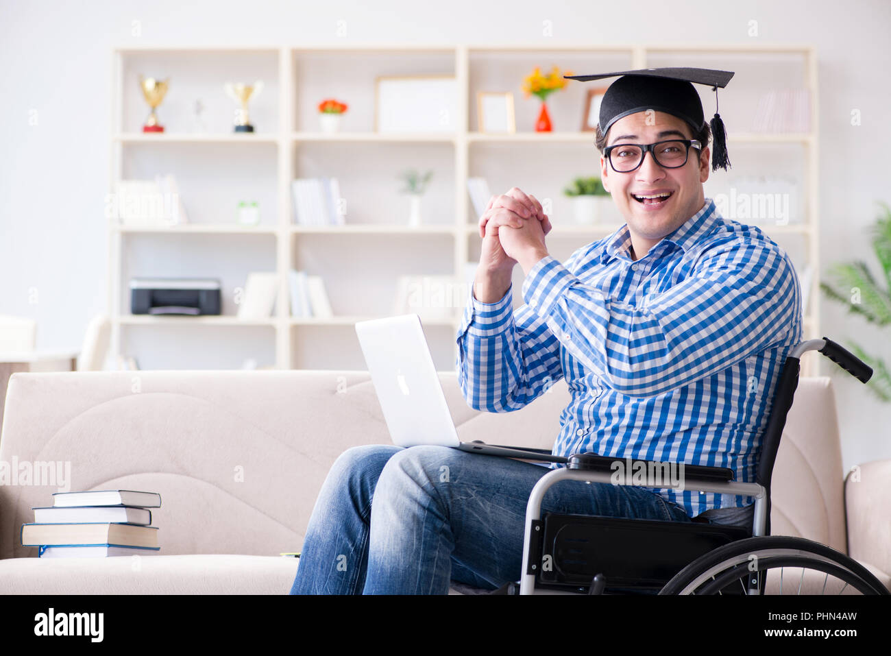 Young student on wheelchair in disability concept Stock Photo - Alamy