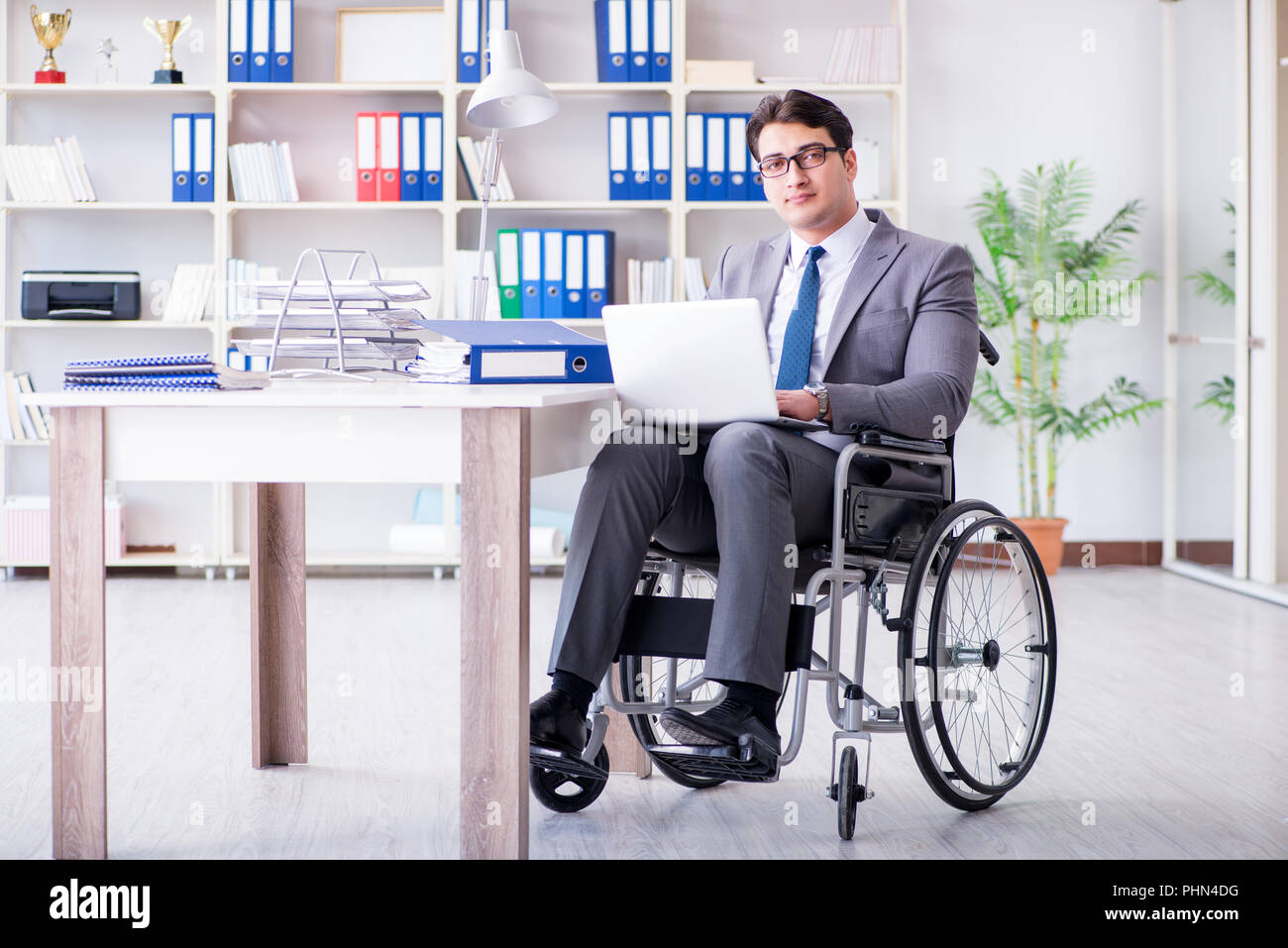Disabled businessman working in the office Stock Photo - Alamy
