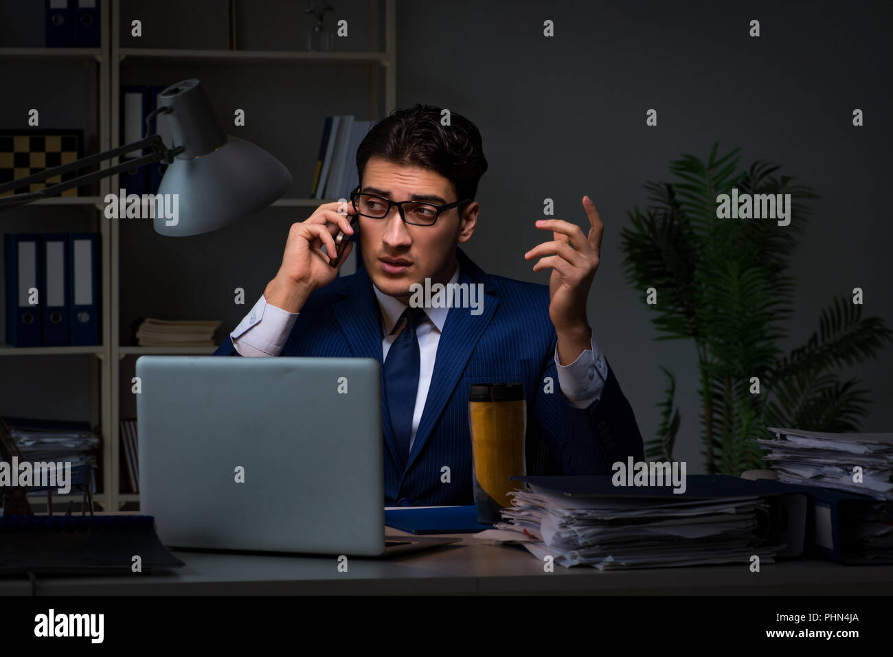 Employee working late to finish important deliverable task Stock Photo ...