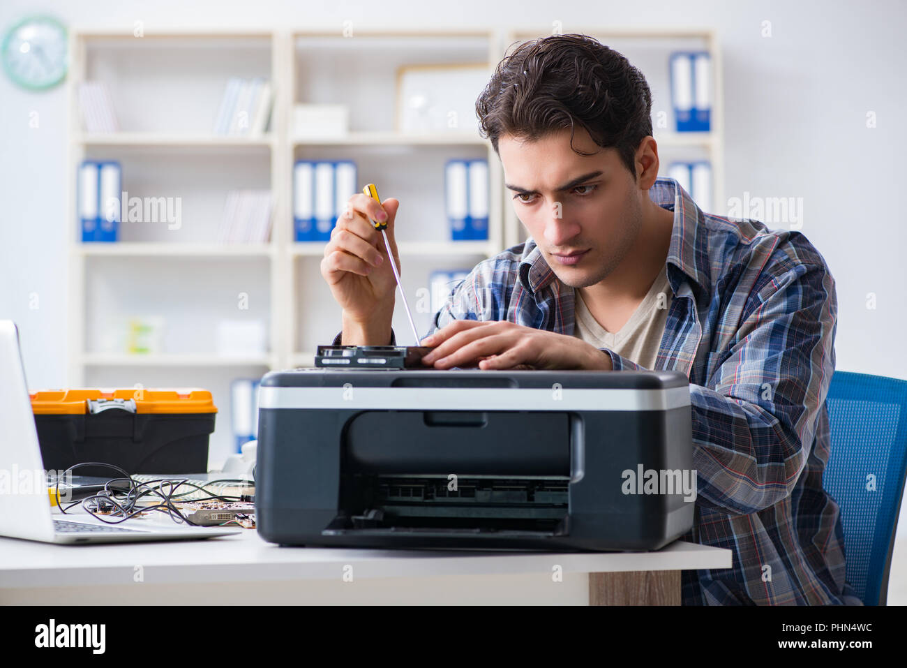 Hardware repairman repairing broken printer fax machine Stock Photo - Alamy