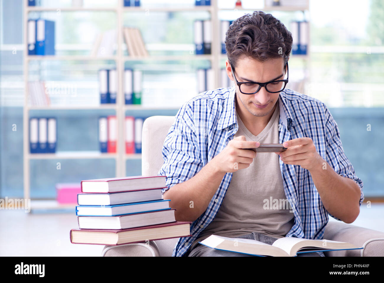 Student reading books and preparing for exams in library Stock Photo ...