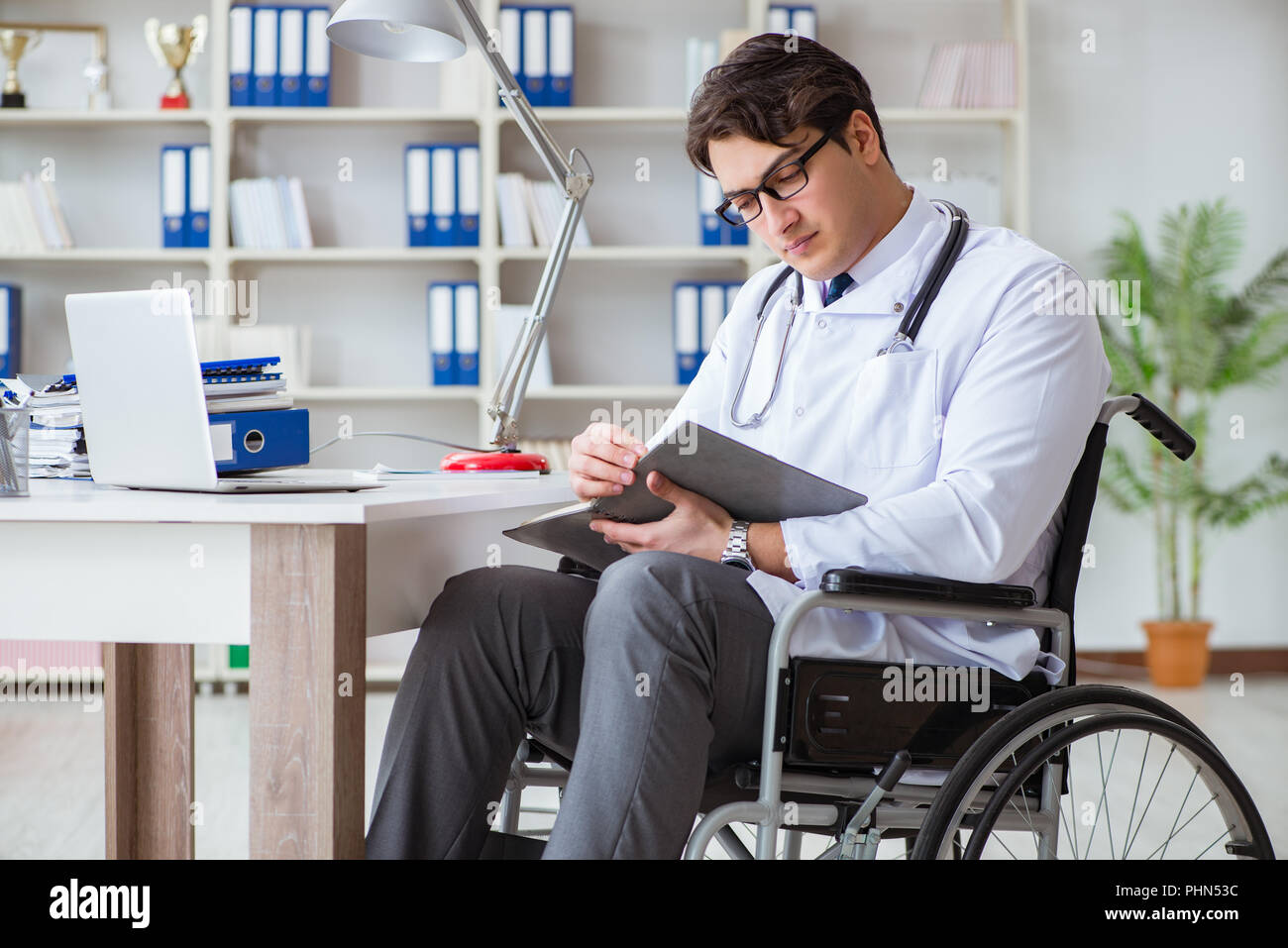 Disabled doctor on wheelchair working in hospital Stock Photo - Alamy