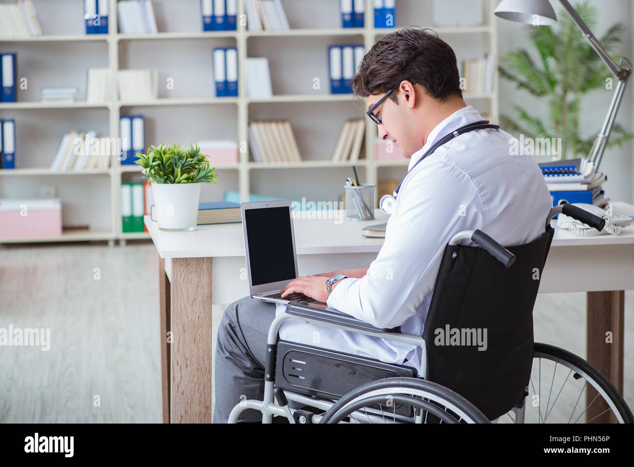 Disabled doctor on wheelchair working in hospital Stock Photo - Alamy
