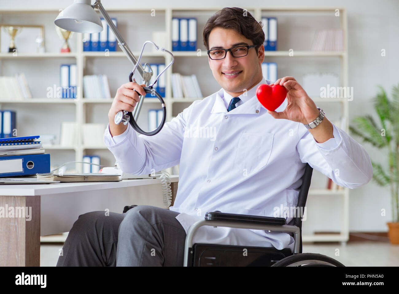 Disabled doctor on wheelchair working in hospital Stock Photo - Alamy