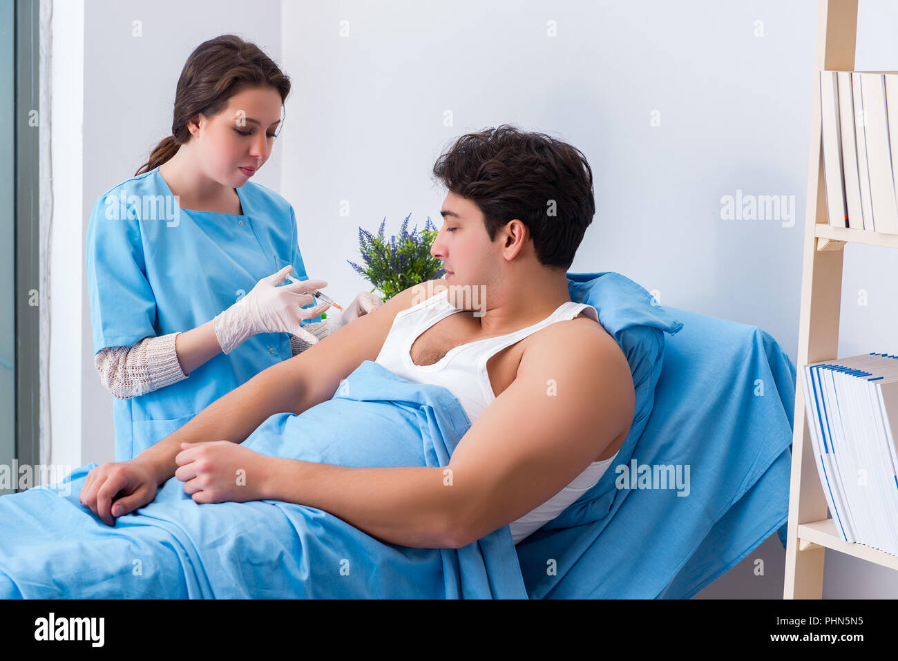 Doctor doing medical injection in hospital room Stock Photo - Alamy