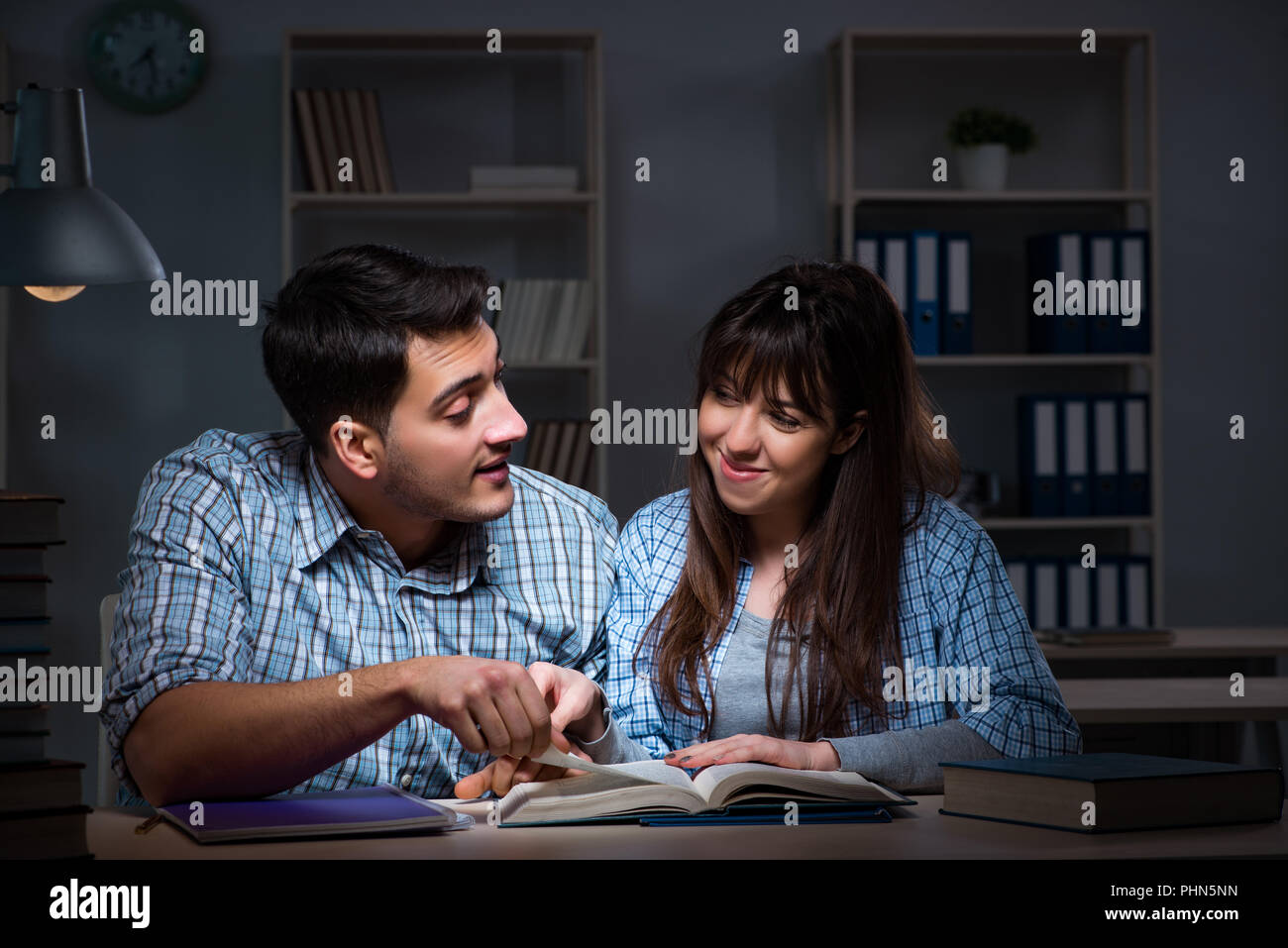 Two students studying late at night Stock Photo - Alamy
